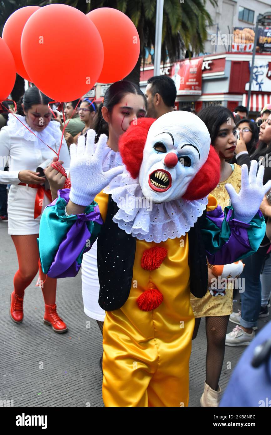 A man disguised as Pennywise (IT) is seen taking part during the march ...