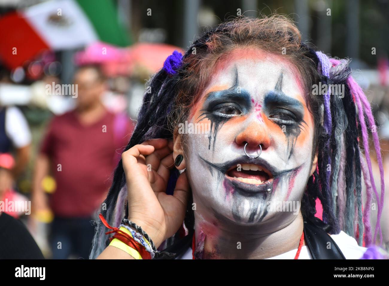 A participant disguised as clown is seen taking part during the march ...