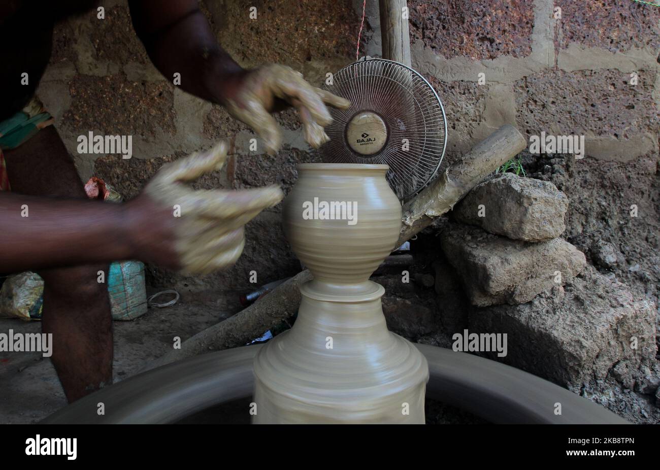 Traditional potters are busy to making earthen pots and lamps at their ...