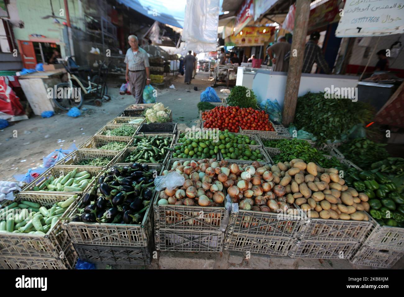 A Palestinian vendor sells Vegetables at the popular Fras market in ...