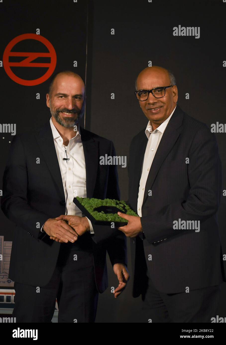 Uber CEO Dara Khosrowshahi (L) presents a memento to Dr. Mangu Singh ...
