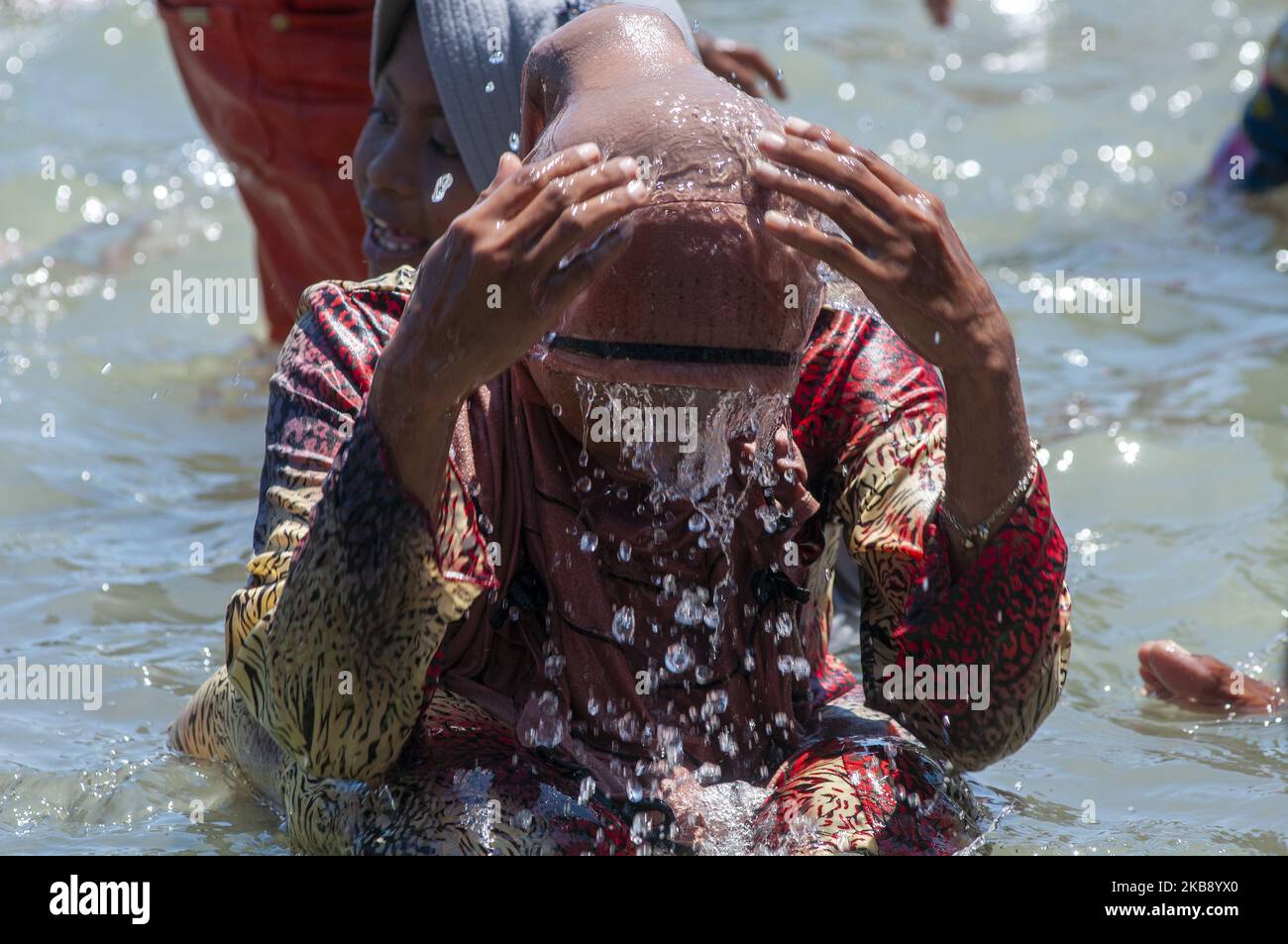 Residents throw themselves into the sea during the Safar bathing ritual ...