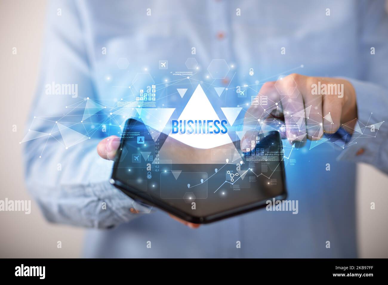 Businessman holding a foldable smartphone, business concept Stock Photo ...