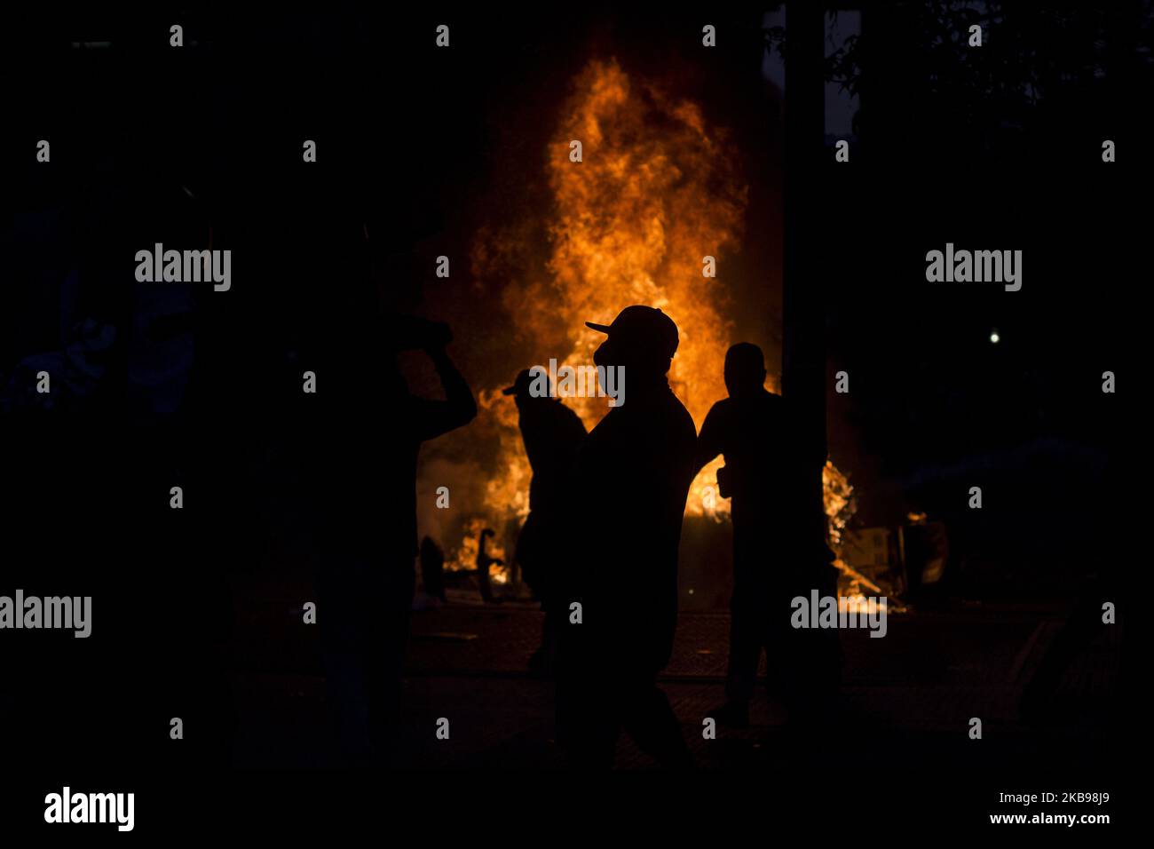 People clash with riot police in Santiago, Chile, on October 25, 2019 ...