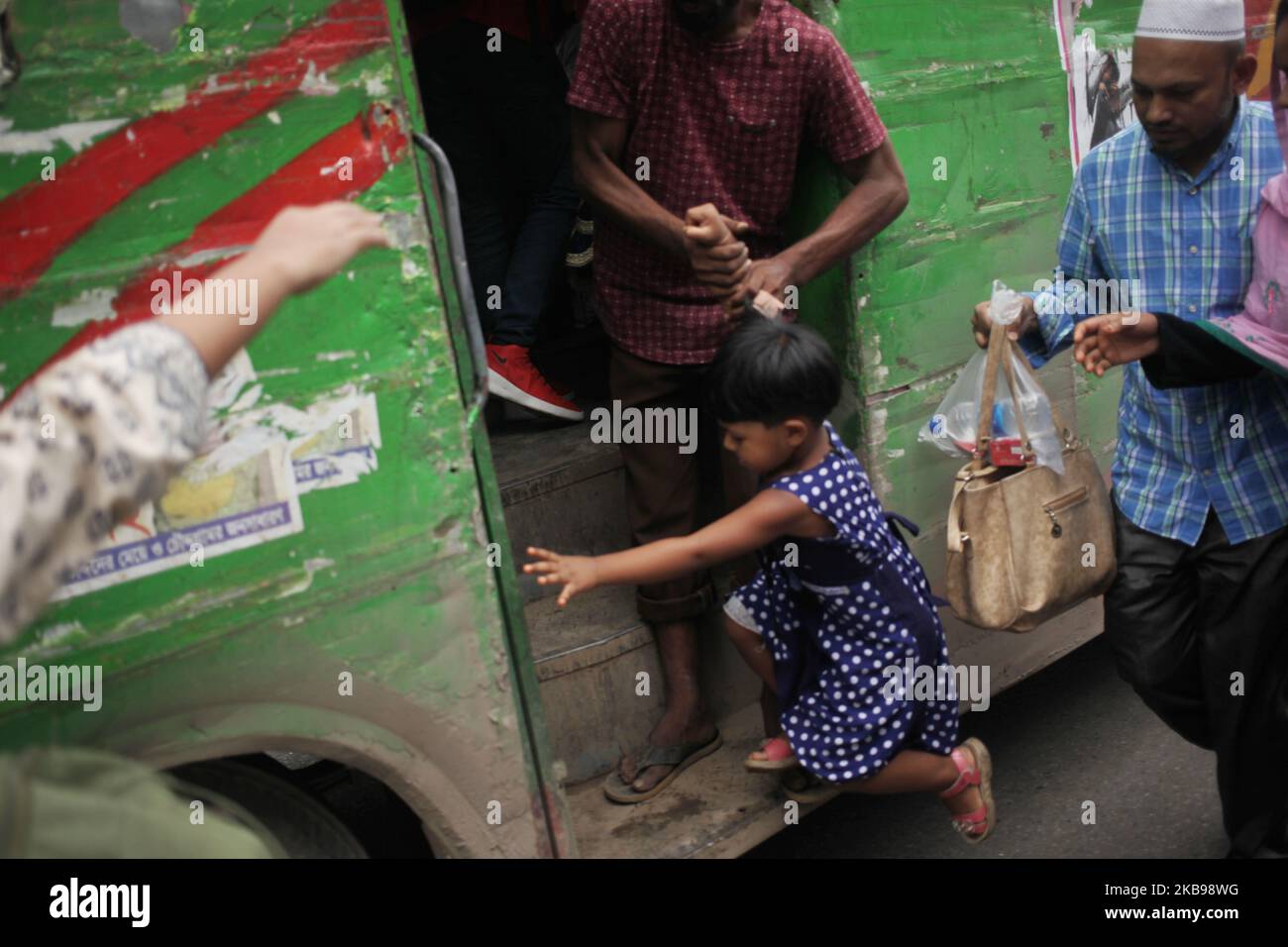 A bus conductor seen pulling a child passenger on a running bus in ...