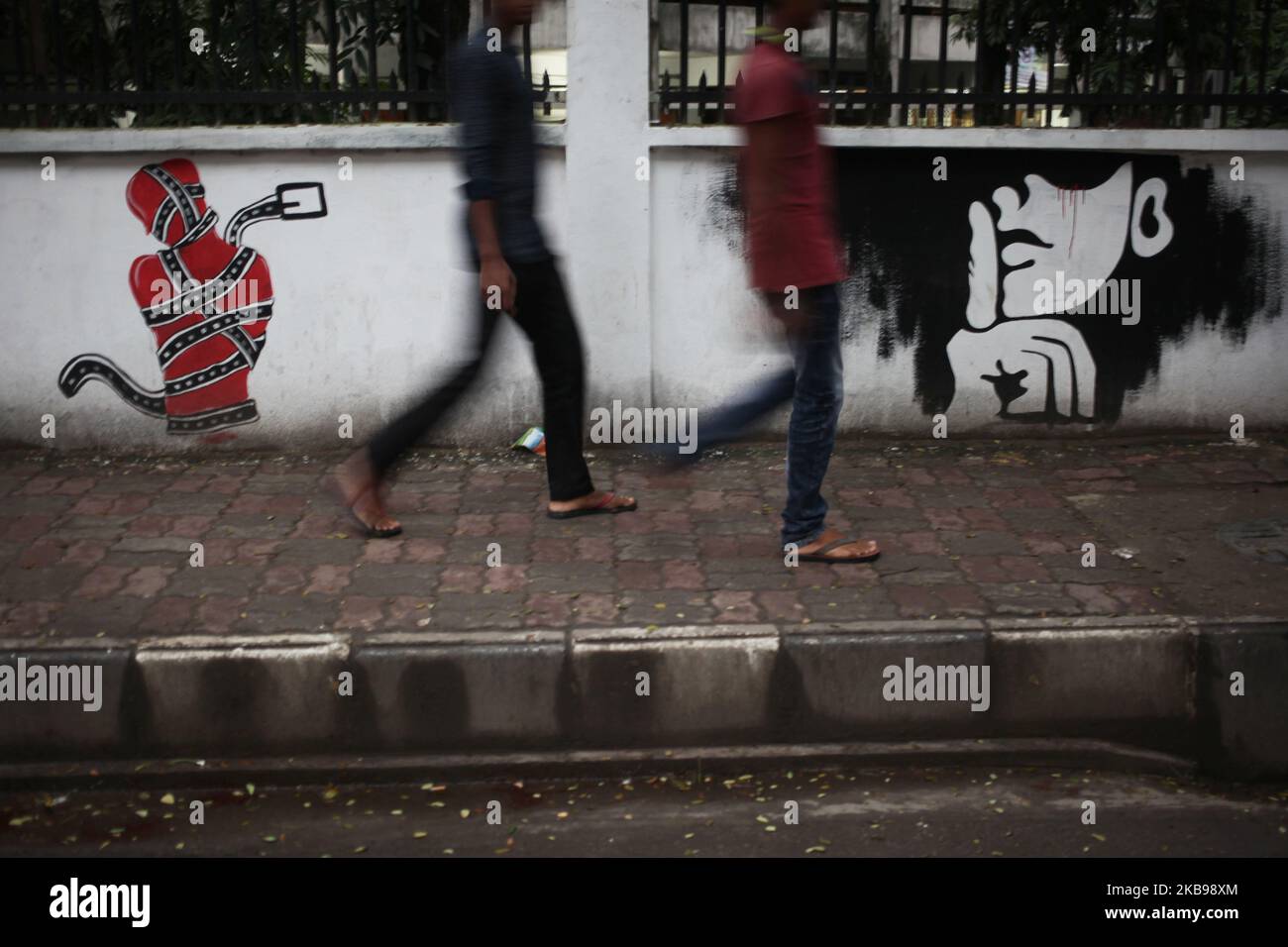 People walk past a wall painting made by students of Bangladesh ...