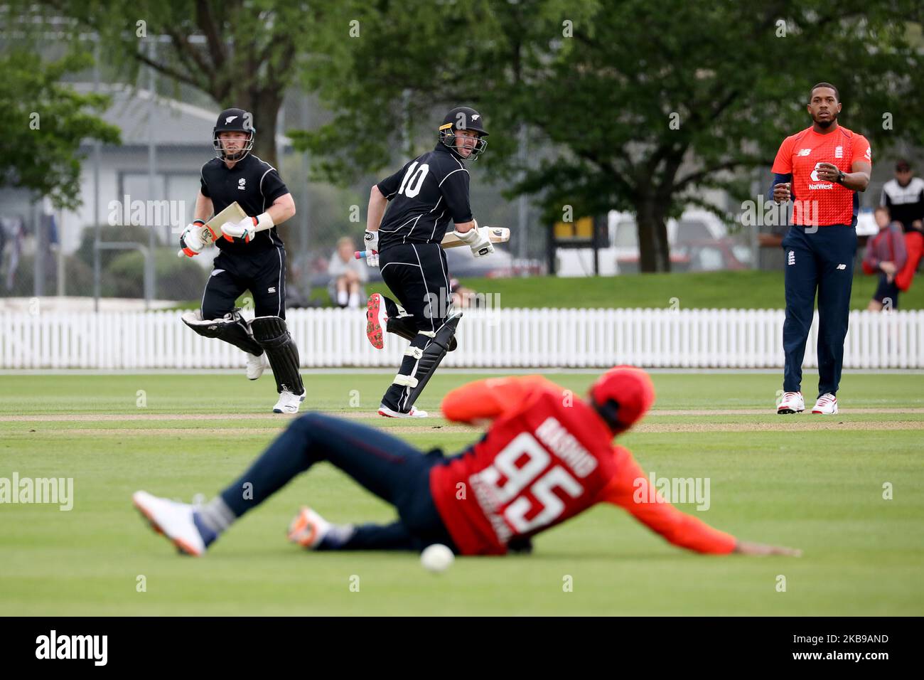 Tim Seifert (L) and Colin Munro of New Zealand XI run between the ...
