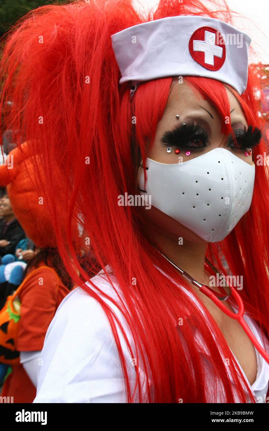 A participant in costume poses for a photo during a Halloween event in ...