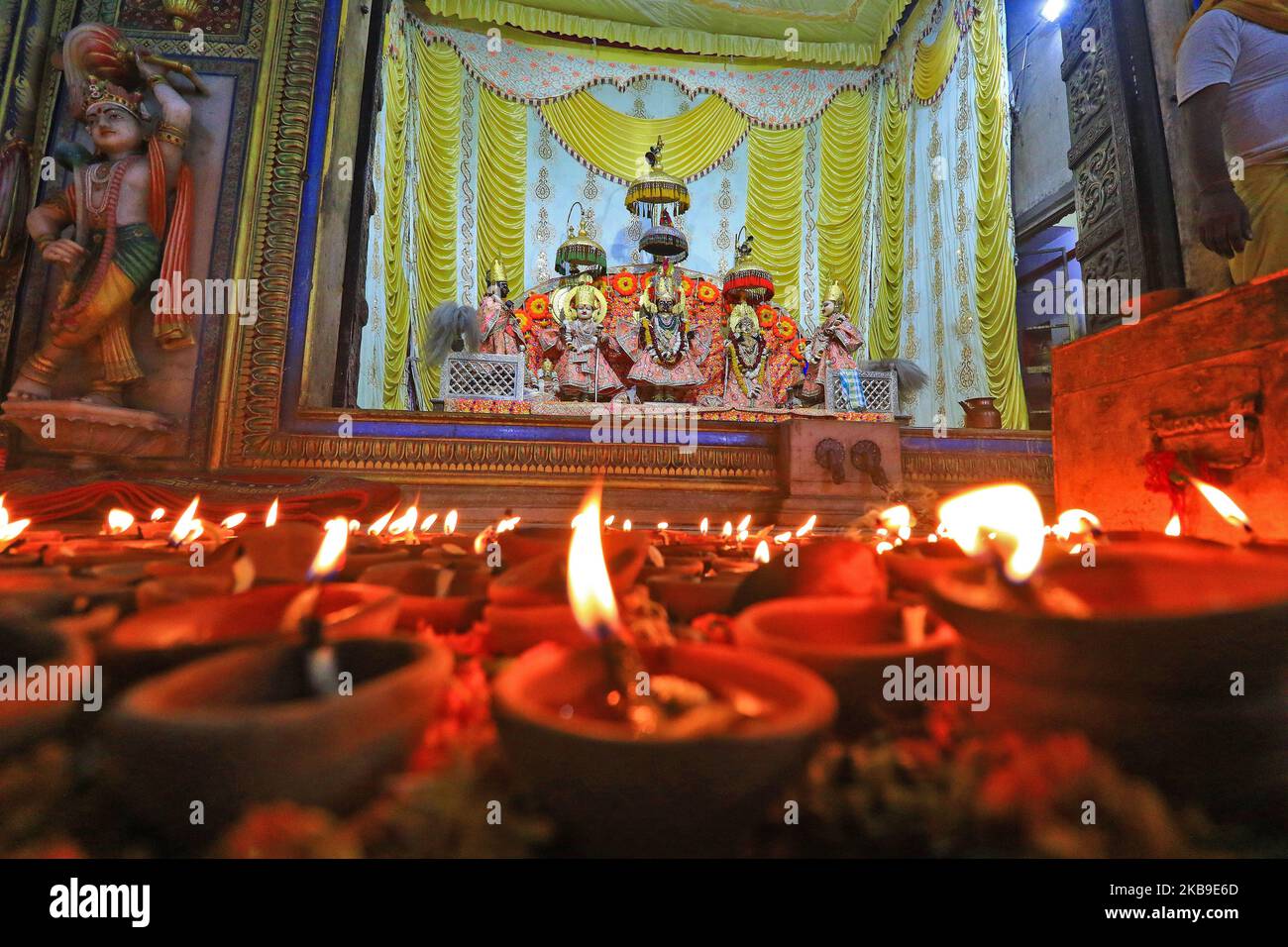 Indian women lights earthen lamp 'Diyas' at Lord Ramchandra Ji Temple ...
