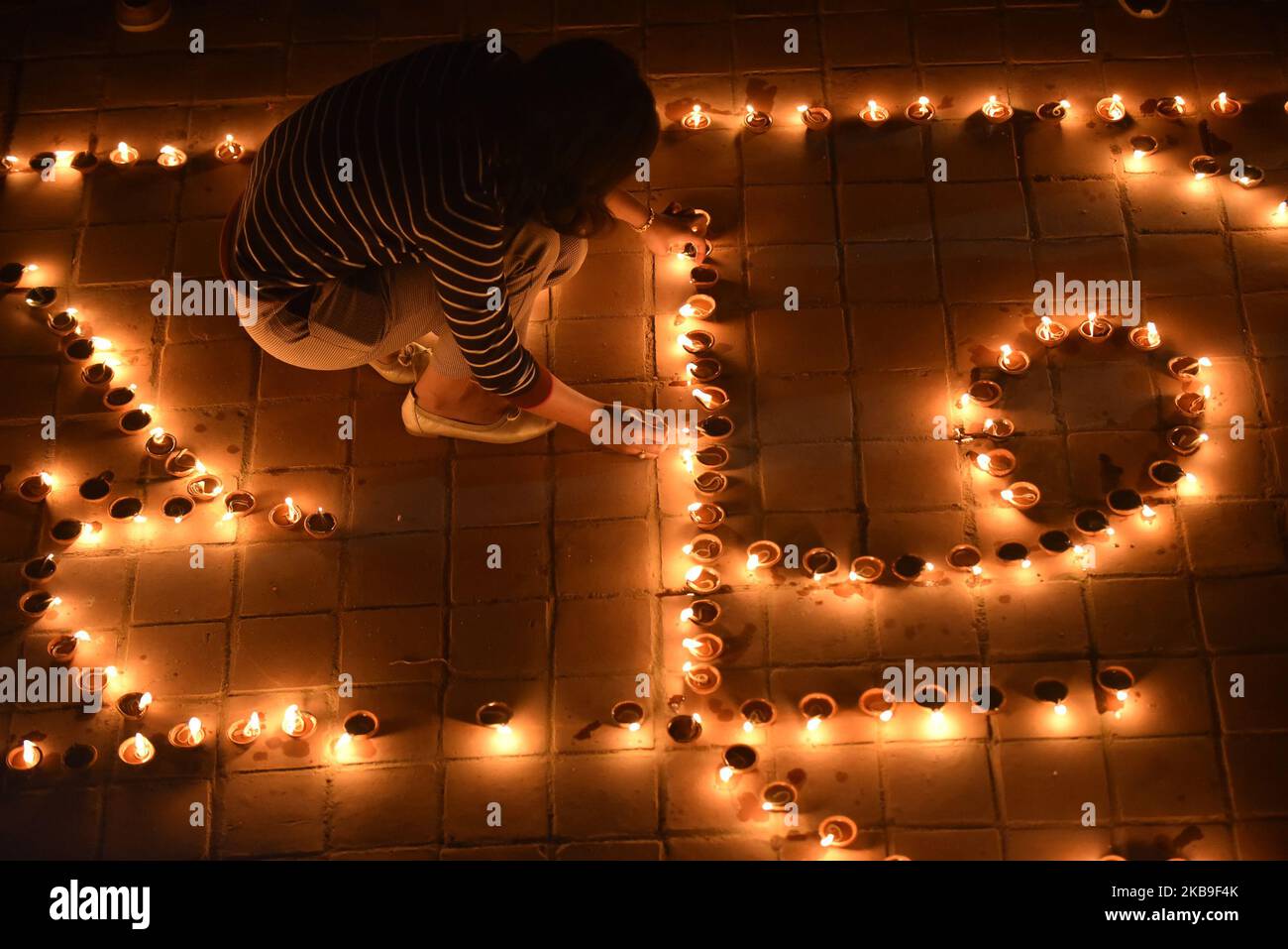 Nepalese people lightening oil lamp during eve of Newari New Year 1140 ...