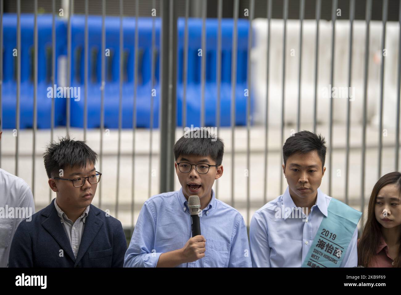 Pro-democracy activist Joshua Wong (C) and Kelvin Lam (R) is seen ...