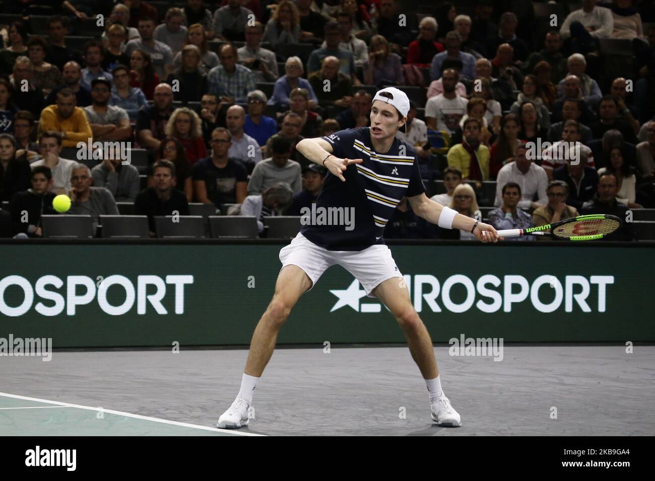 France's Ugo Hubert hits a ball during the men's singles round of 64 of ...