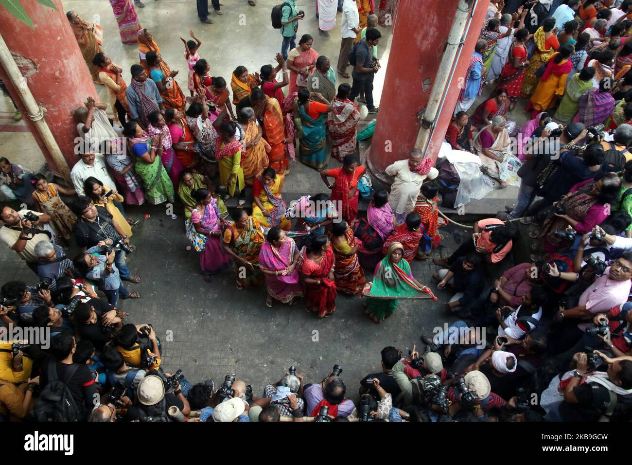 Indian Devotees collecting holy rice during the Annakut Utsav ...