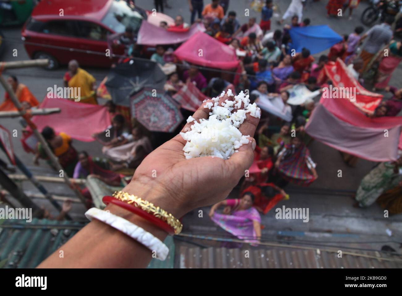 Indian Devotees collecting holy rice during the Annakut Utsav ...