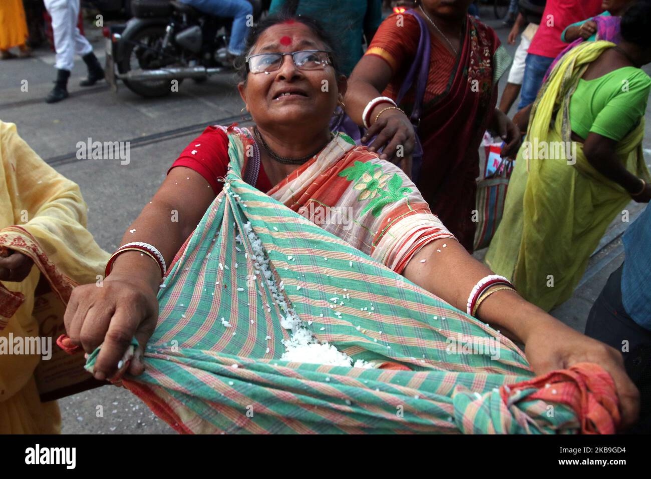 Indian Devotees collecting holy rice during the Annakut Utsav ...