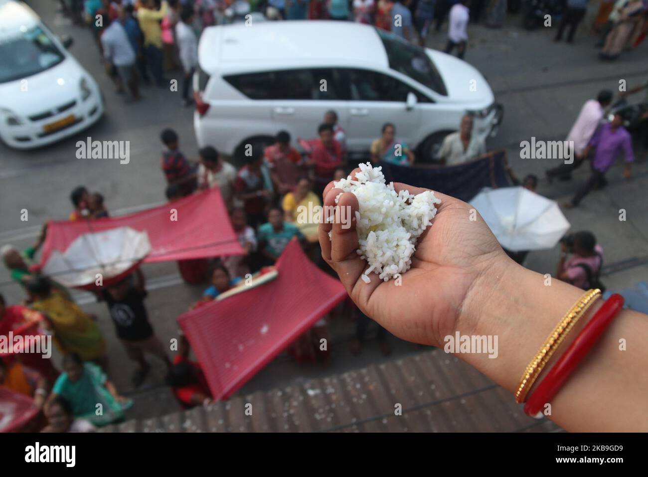 Indian Devotees collecting holy rice during the Annakut Utsav ...