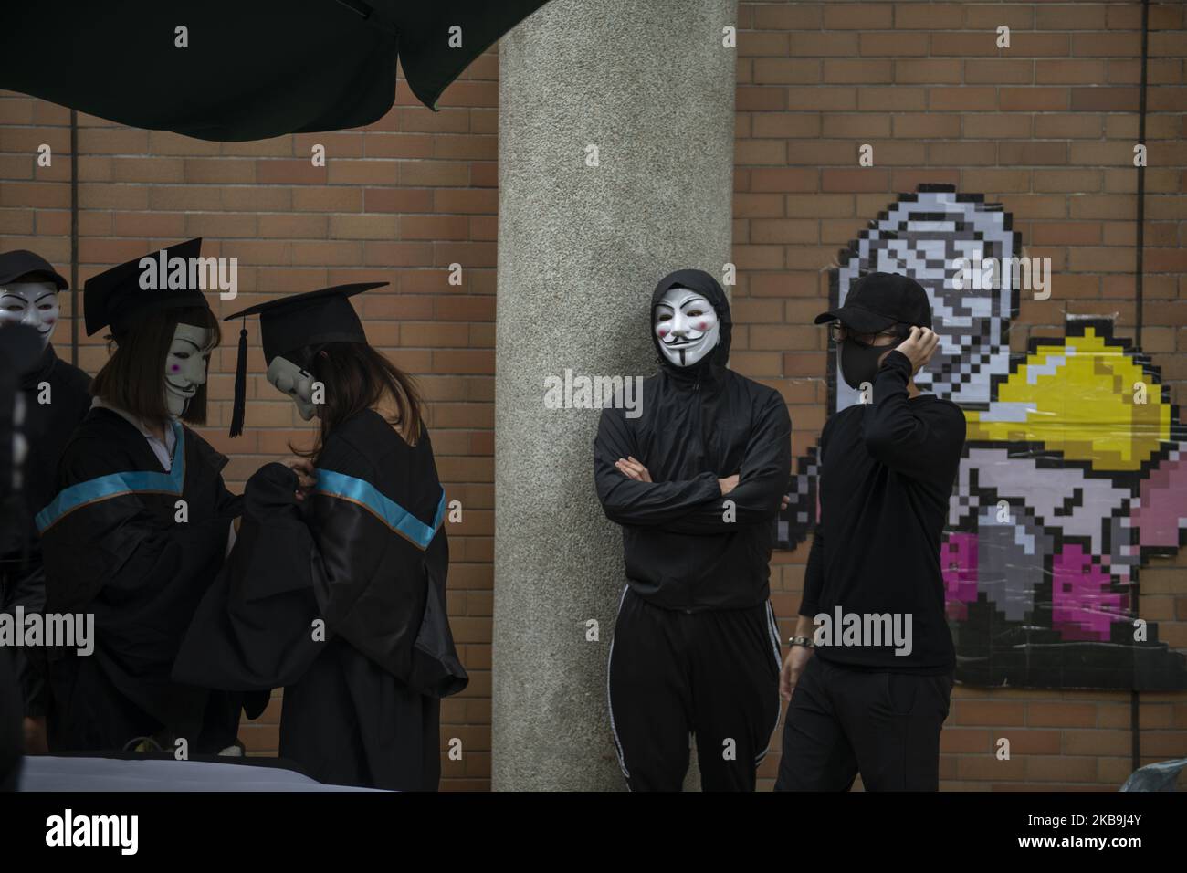 Protesters wearing Guy Fawkes Mask are seen in Polytechnic University ...