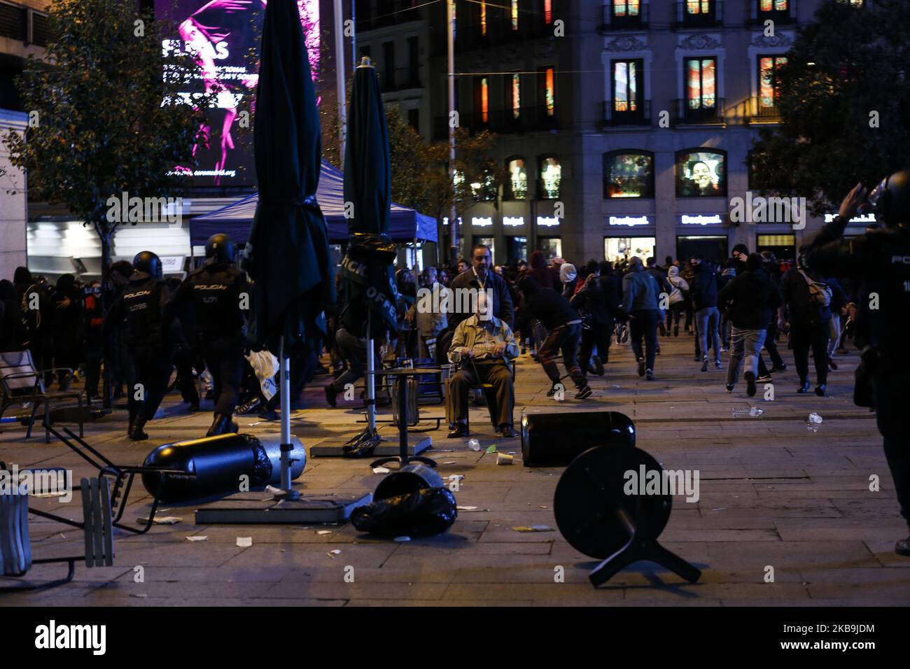 A man remains sit while demonstrators and police clashed in Plaza de ...