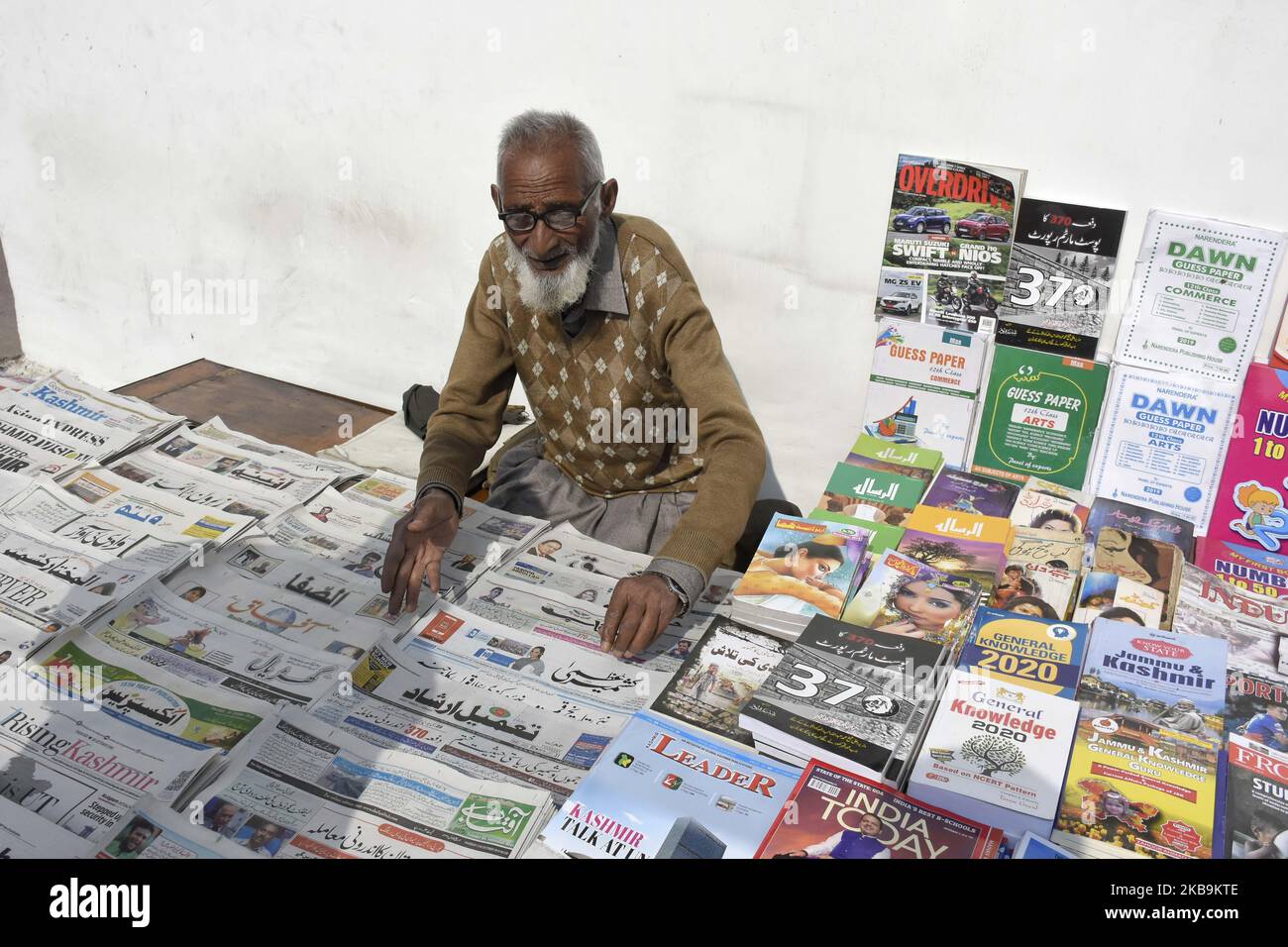 A Newspaper vendor sells newspapers during shutdown in Srinagar, Jammu ...
