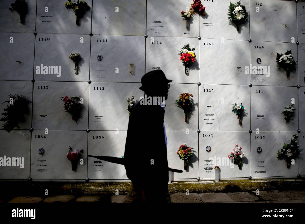 A man walks past graves at a cemetery during the annual observance of ...