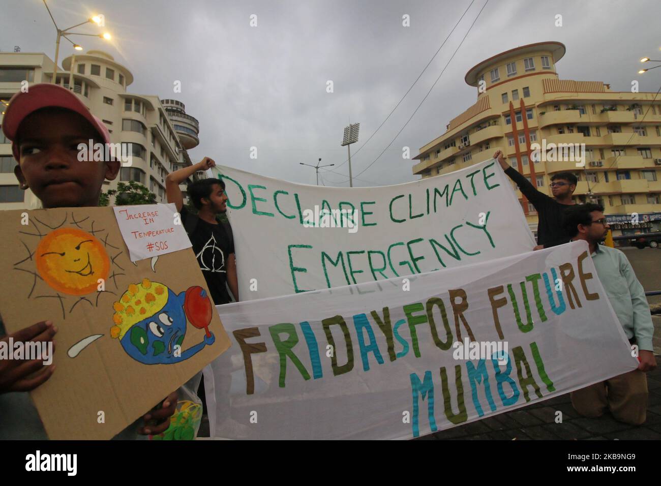 Students and people hold placards as they participate in a protest ...