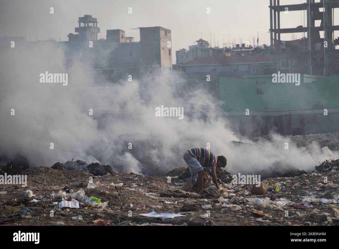 A man seen working as toxic garbage are burning beside a road near The ...