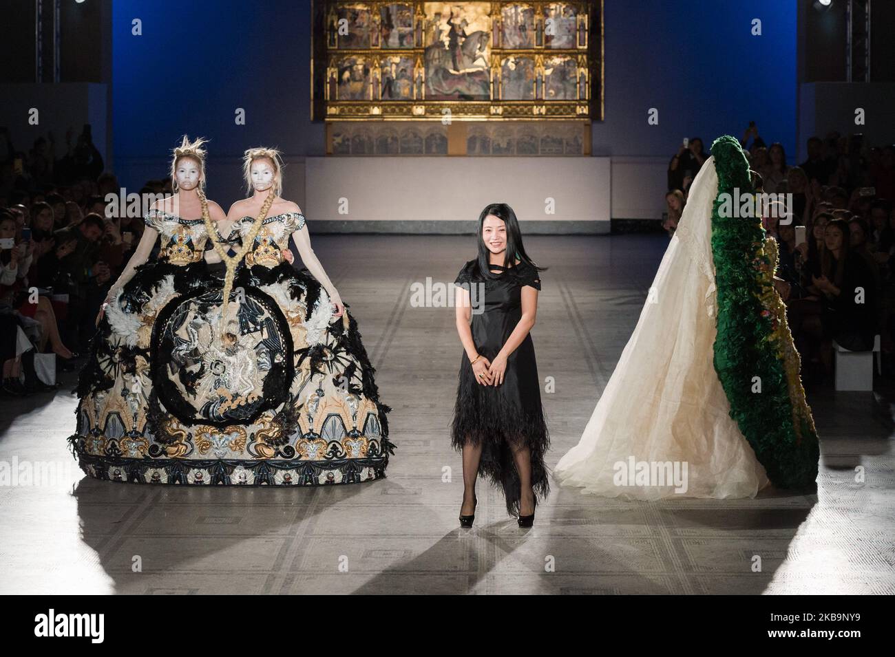 Chinese fashion designer Guo Pei acknowledges the audience at the end ...