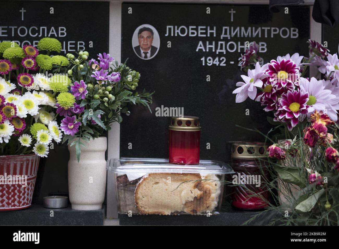 Food and flowers are left at a grave in the Central Cemetery in Sofia ...