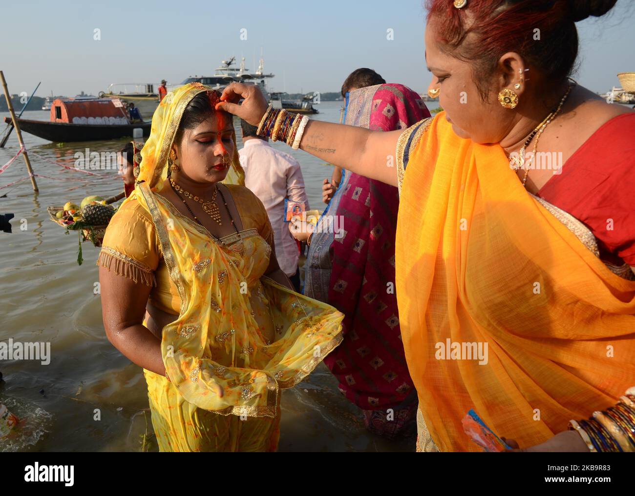 Indian Hindu women devotees offering prayers to the Sun God on the ...