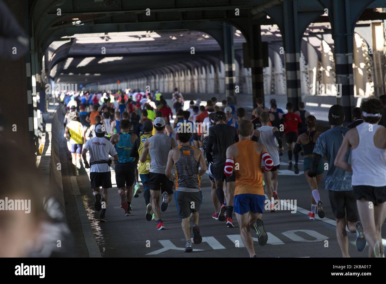 Runners cross the Queensboro Bridge at the New York City Marathon ...