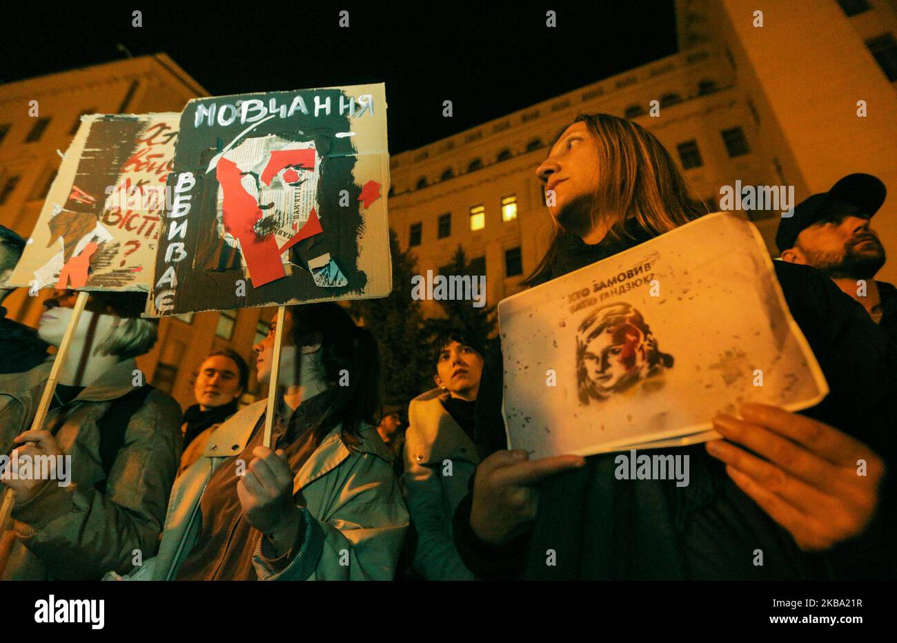 A women hold a placards which says "Who kill Gandziuk?", "Who kill ...