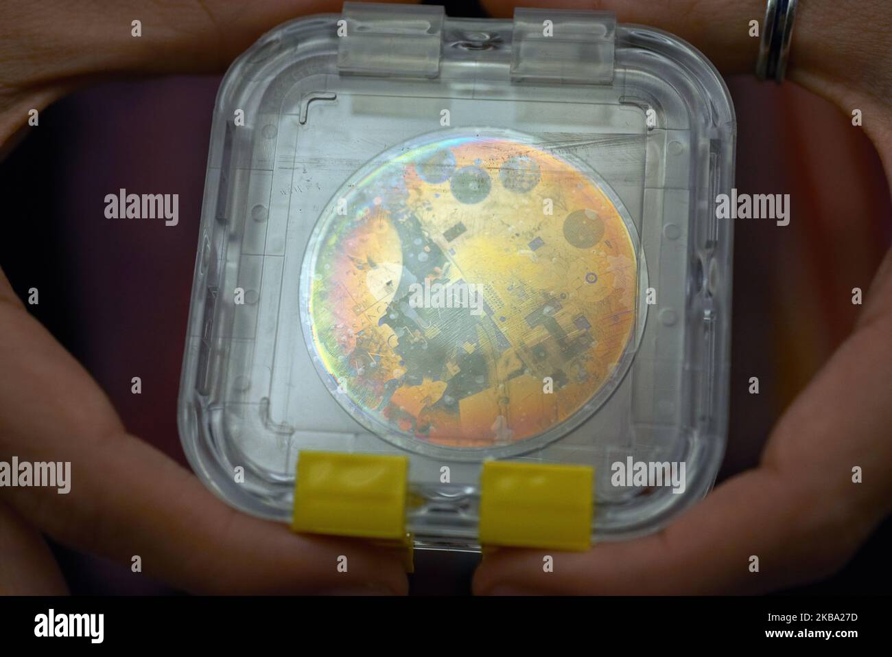 A woman shows the prototype sapphire disk. For the fiftieth anniversary ...