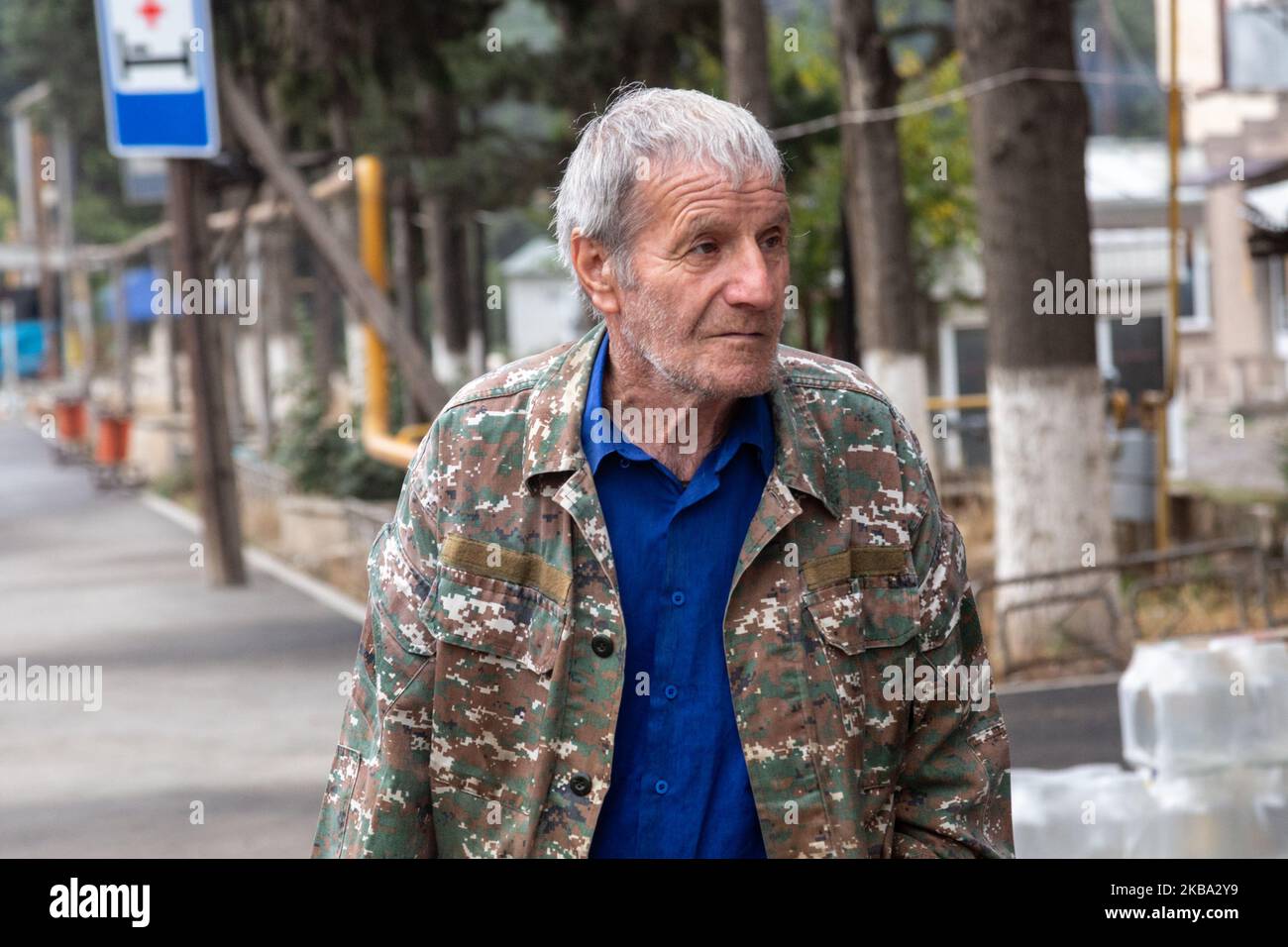 An elderly man stands on a street in Martakert, Republic of Nagorno ...