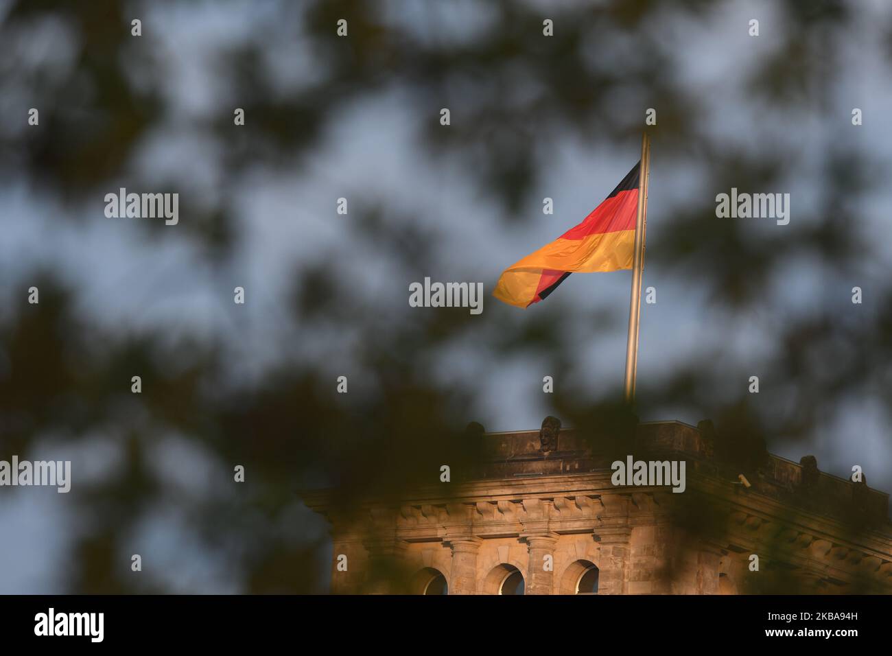 A view of a German flag over the Reichstag building, the seat of the ...