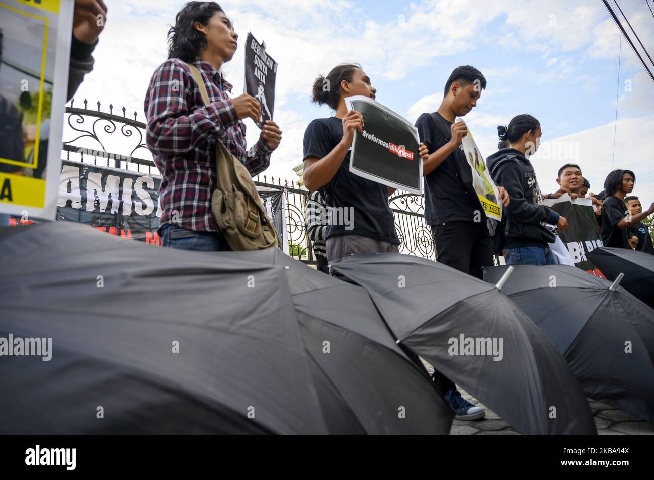Humanitarian activists carry banners at the Kamisan Action in front of ...