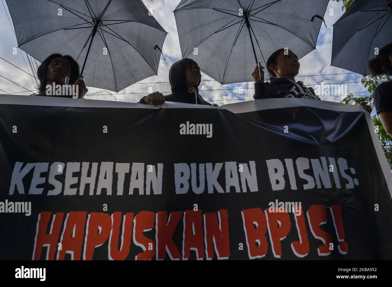 Humanitarian activists carry banners at the Kamisan Action in front of ...