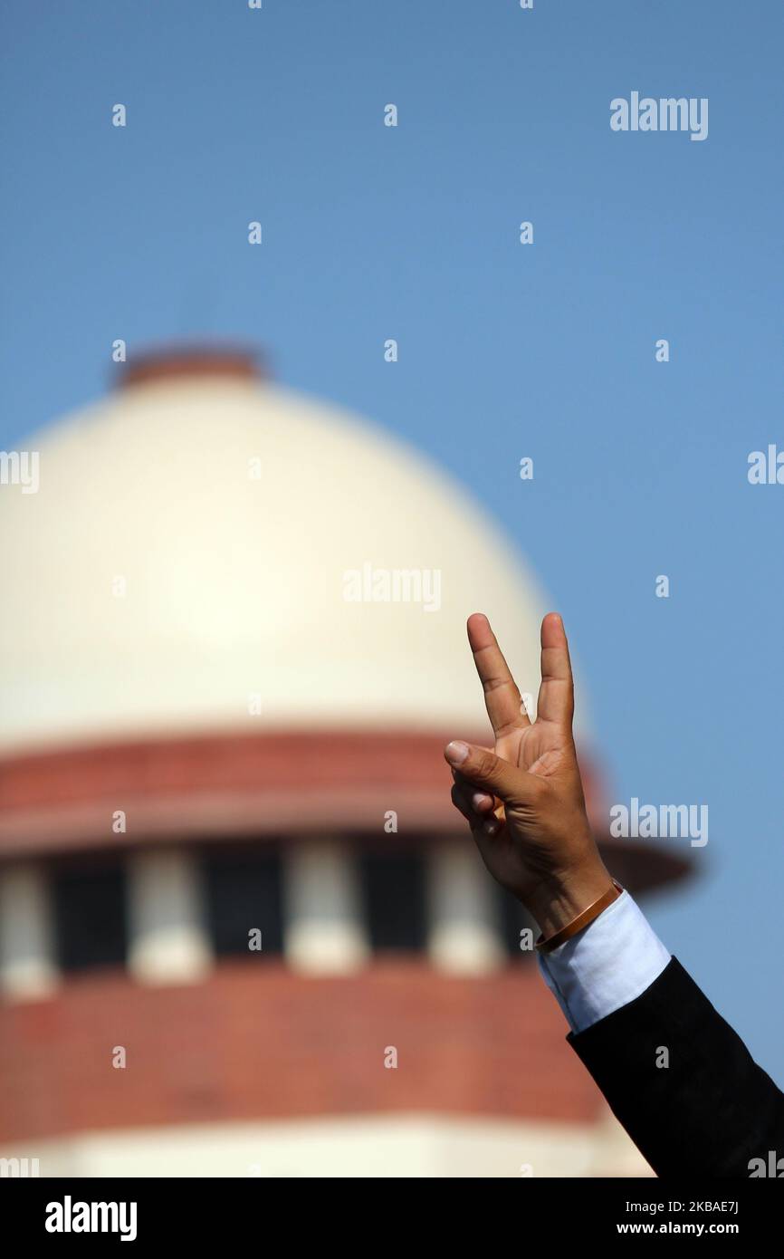 People show victory sign after Supreme Courts ruling on a disputed ...