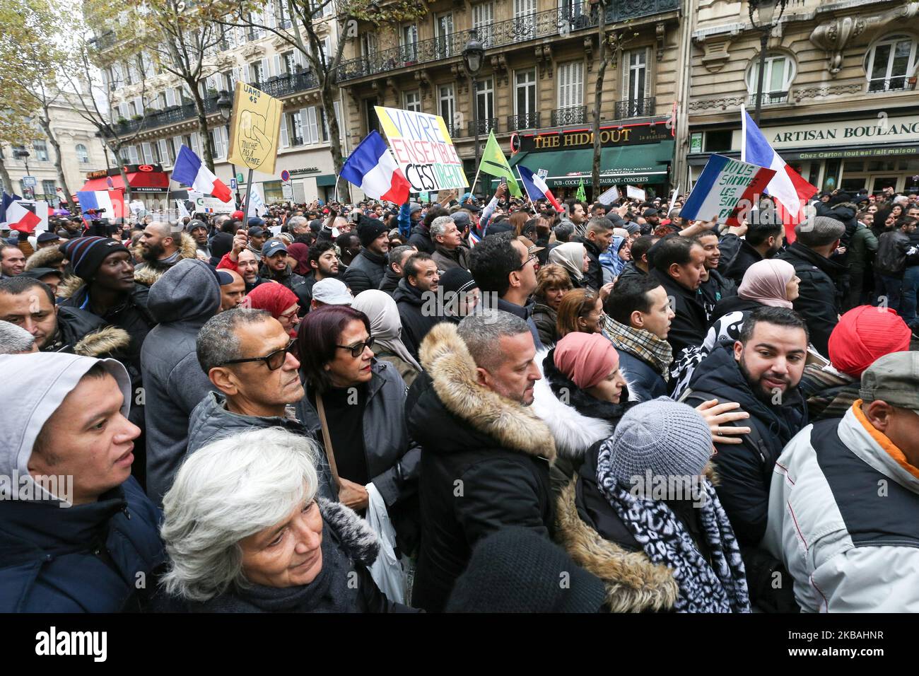 People wave French national flags, chant slogans and hold placards as ...