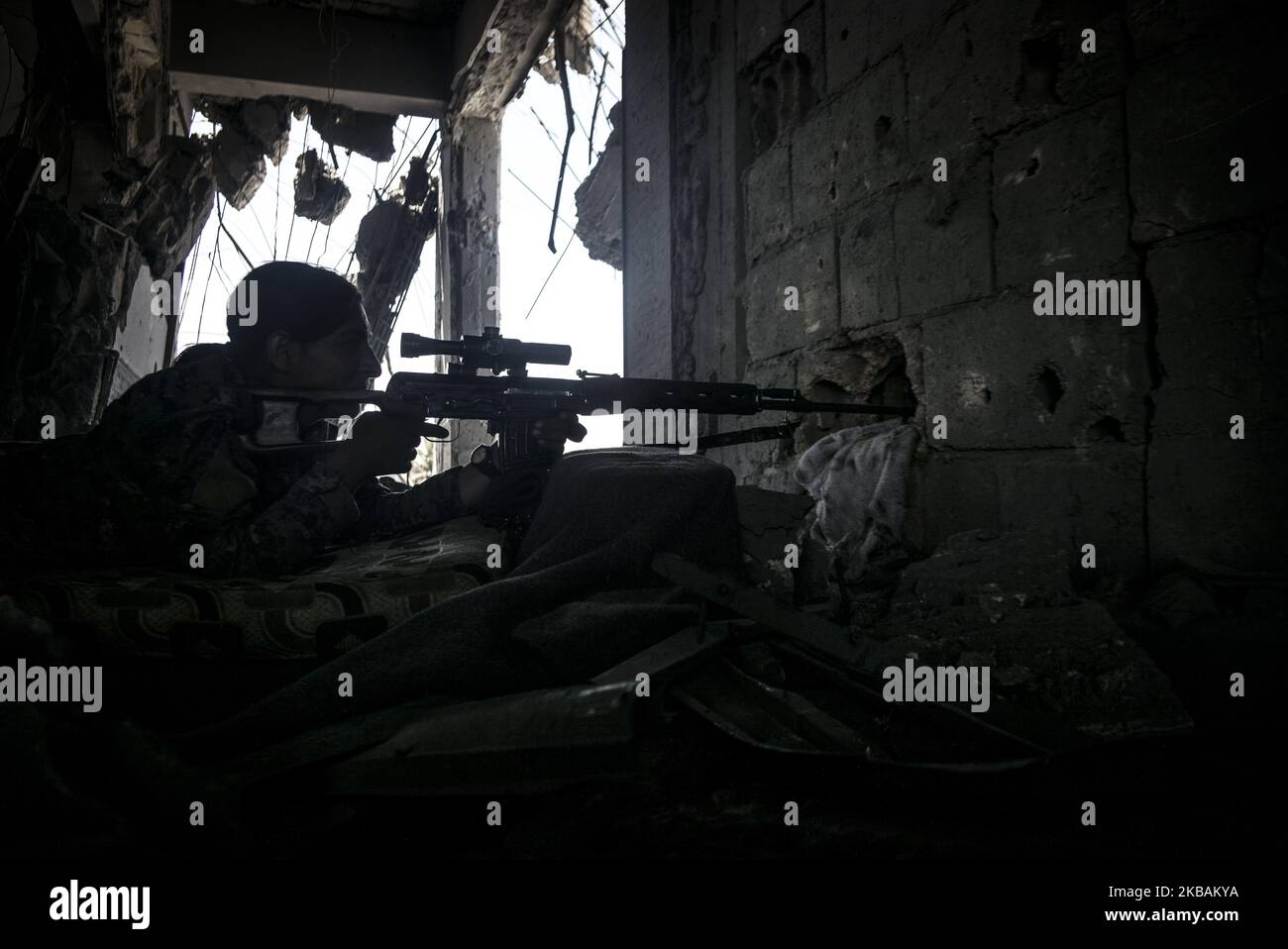 A YPJ sniper takes high position in a 5 storey building overlooking ...