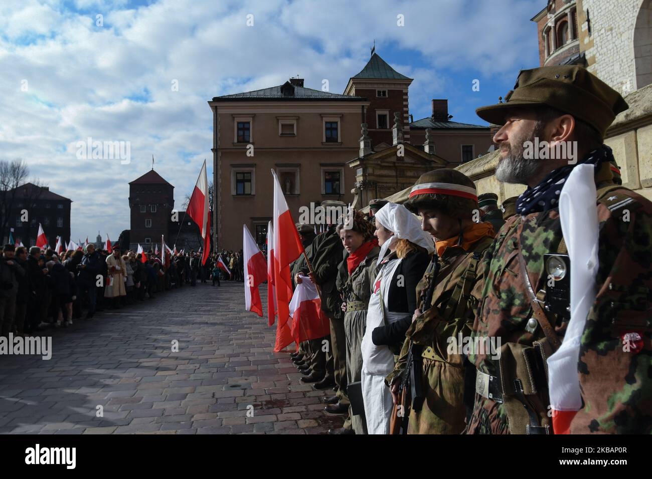 People with Polish national Flags dressed in Historical Polish Military ...