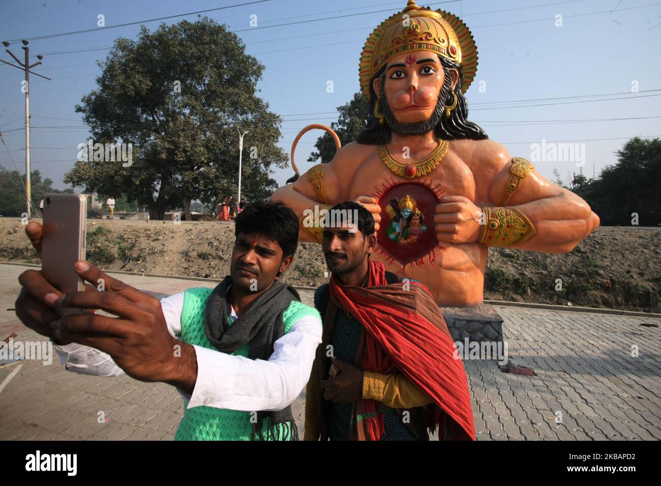 Indian devotees take a selfie in front of idol of hindu monkey faced ...