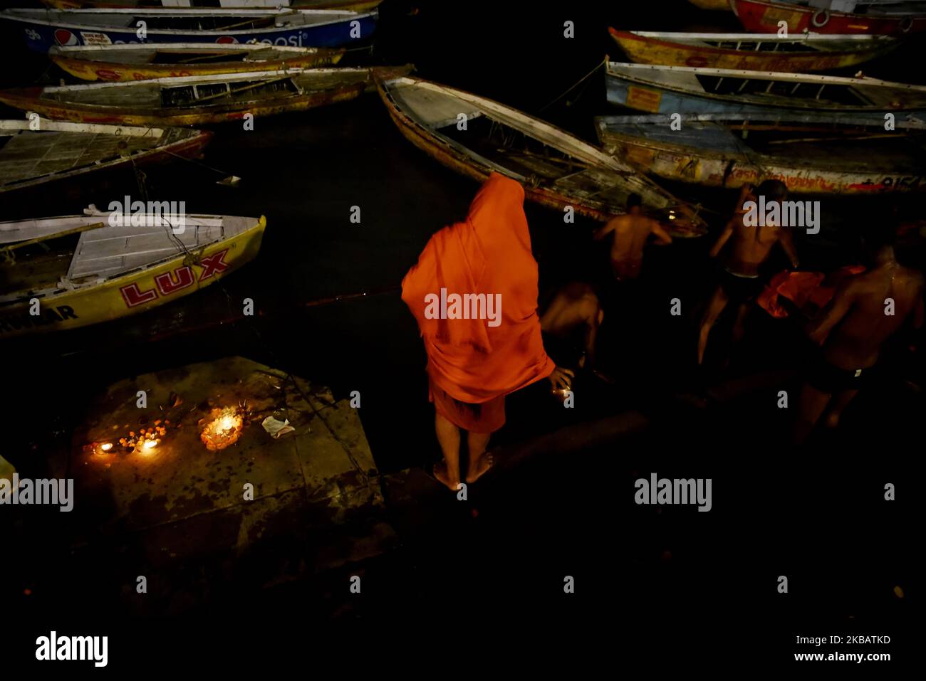 Hindu devotees bath on the river Ganga on the day of Dev Deepawali in ...