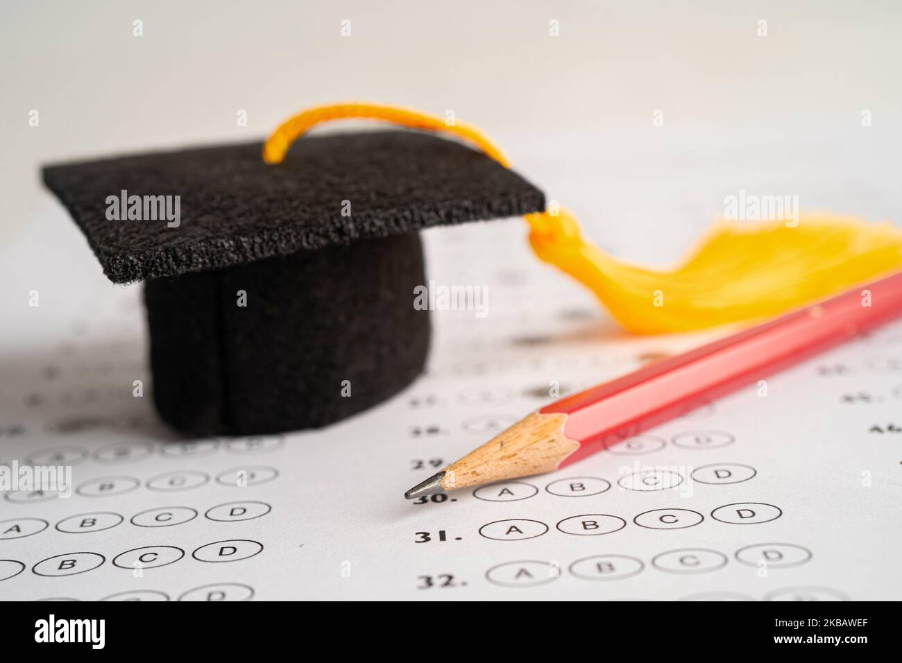 Graduation hat and pencil on Answer sheet background, Education study ...
