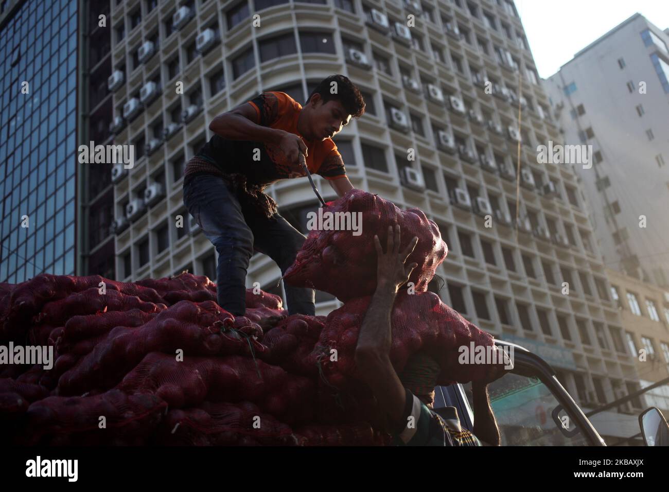 Worker seen unloading onion from a mini truck as onion prices shot past ...