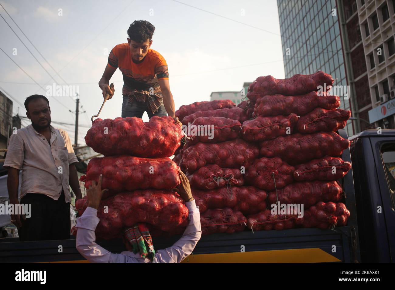 Worker seen unloading onion from a mini truck as onion prices shot past ...