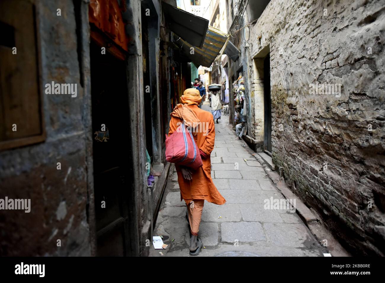 A sadhu walks through a narrow lane in Varanasi, India, 14 November ...