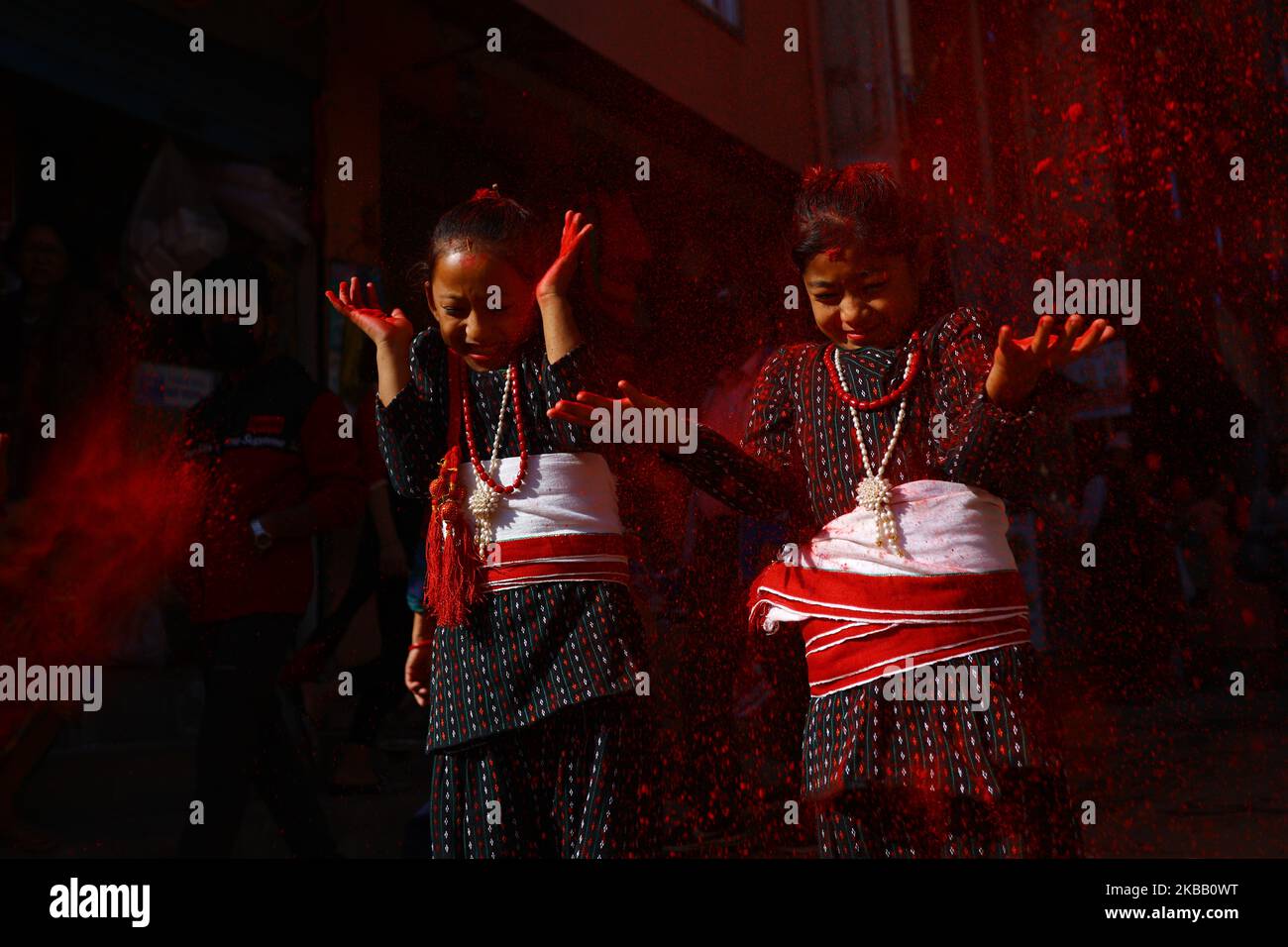 A Nepalese girl throwing vermillion powder during Sindoor Jatra ...