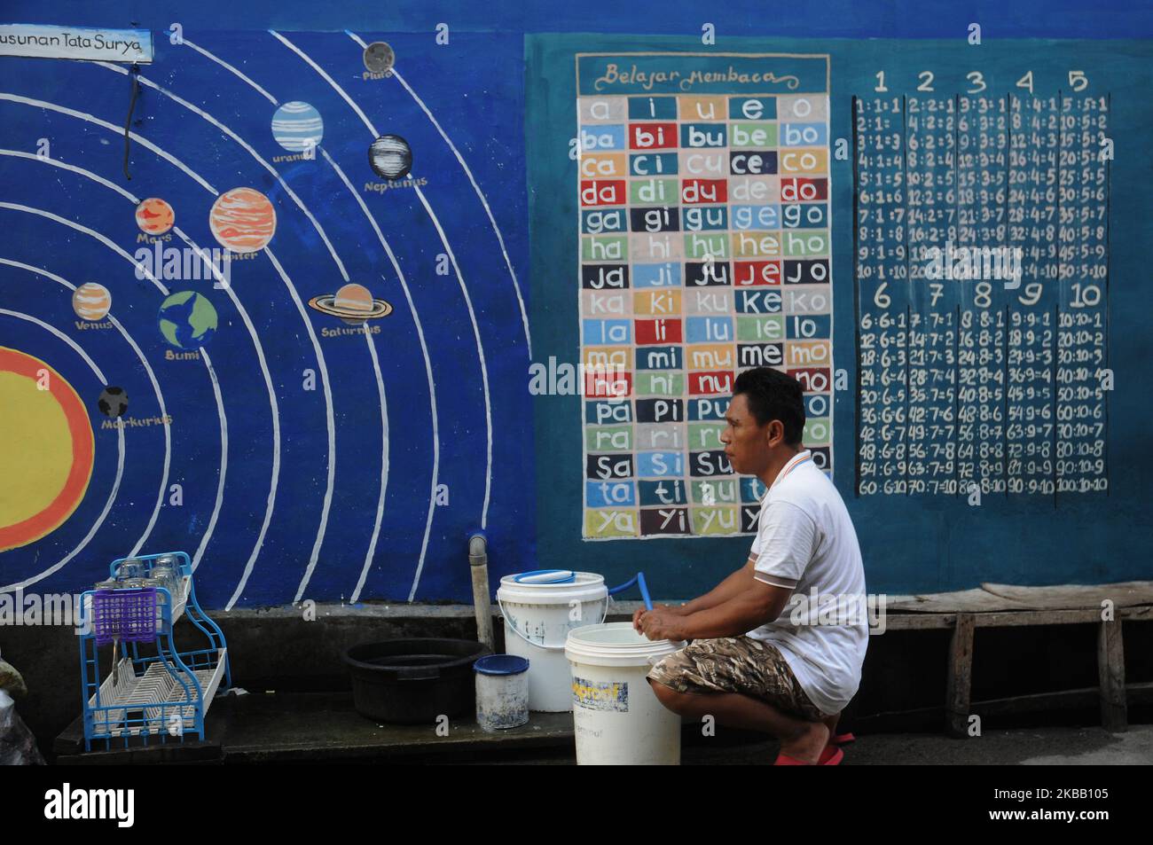 Children with Parents see education Graffiti themed walls in a narrow ...