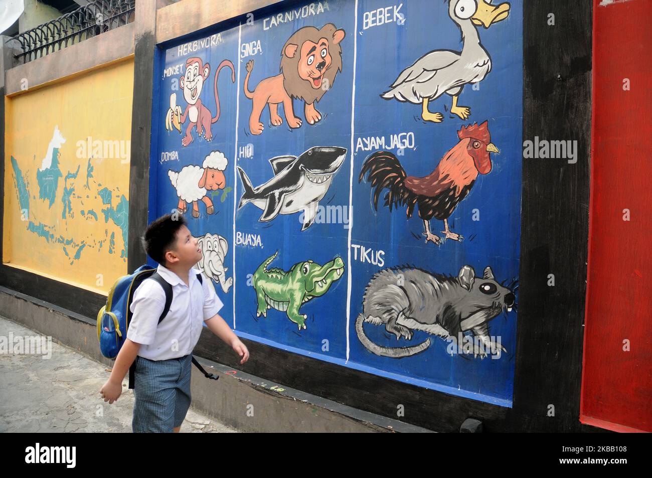 Children with Parents see education Graffiti themed walls in a narrow ...