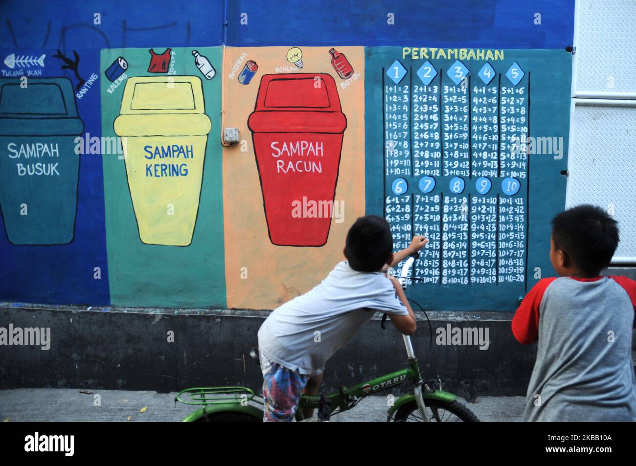 Children with Parents see education Graffiti themed walls in a narrow ...